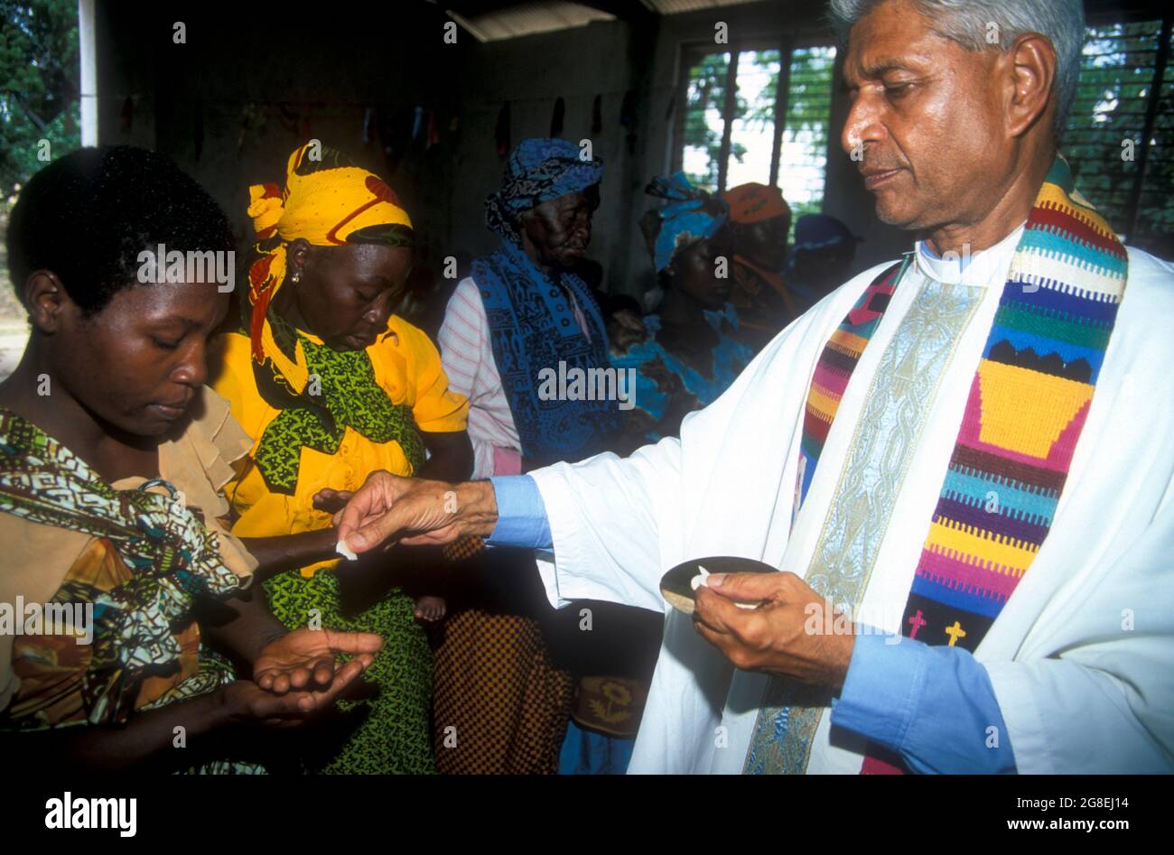 Priest distributing the Holy Sacraments during Communion in a catholic ...