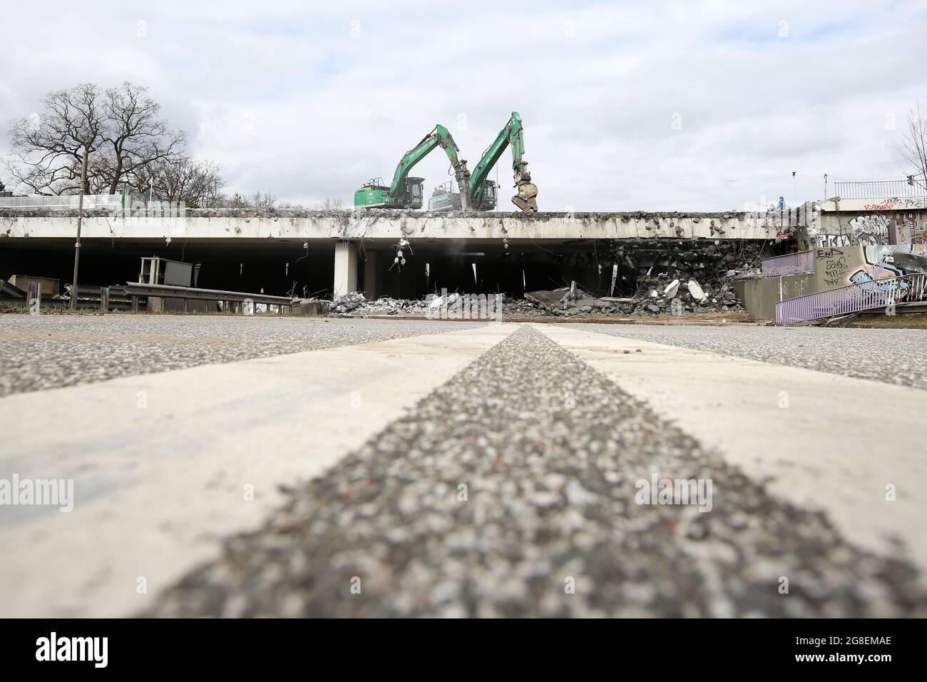 Hamburg, Germany. 19th Mar, 2021. Excavators demolish a bridge over the ...