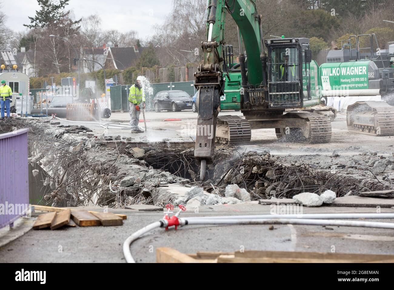 Hamburg, Germany. 19th Mar, 2021. Excavators demolish a bridge over the ...
