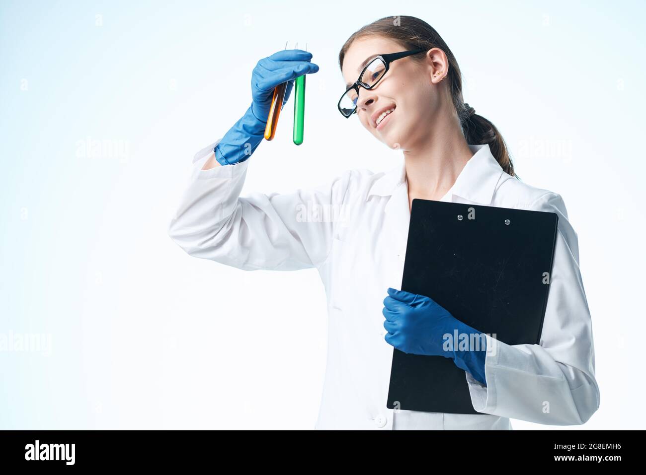 female laboratory assistant in white coat chemical solution research ...