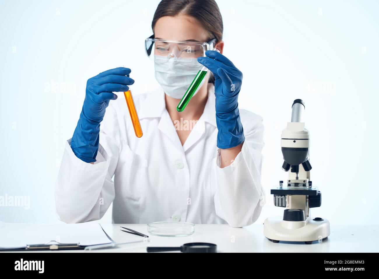 female laboratory assistant wearing yellow glasses chemical solution ...