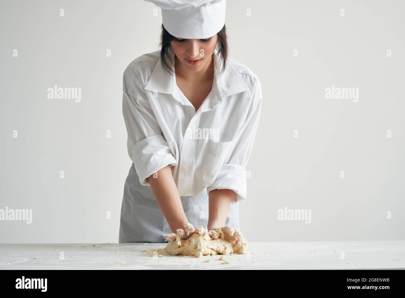 woman chef baker rolls out dough flour cooking work Stock Photo - Alamy