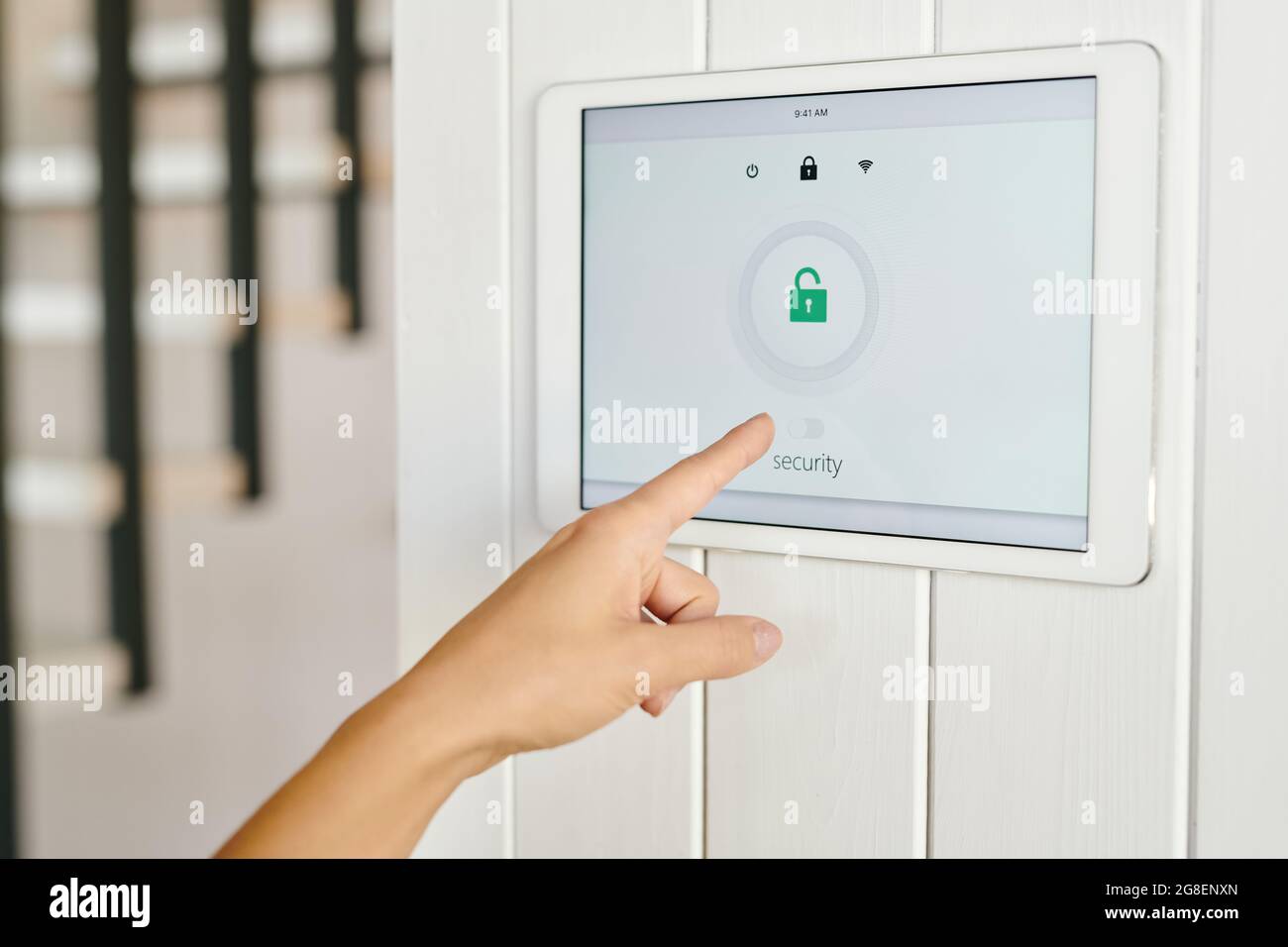 Hand of young woman pointing at display with security symbol on the ...