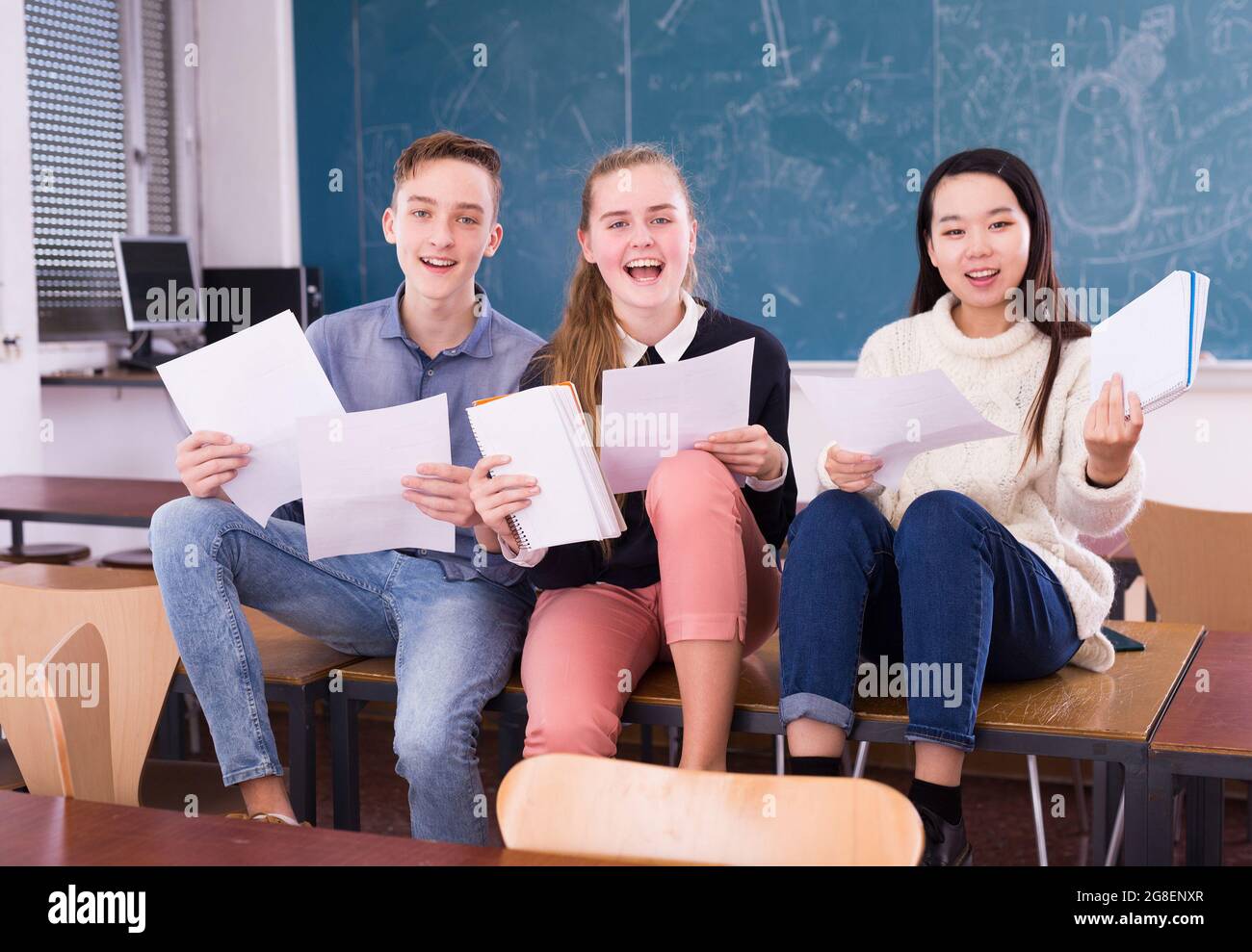 Cheerful teen students in auditorium Stock Photo - Alamy