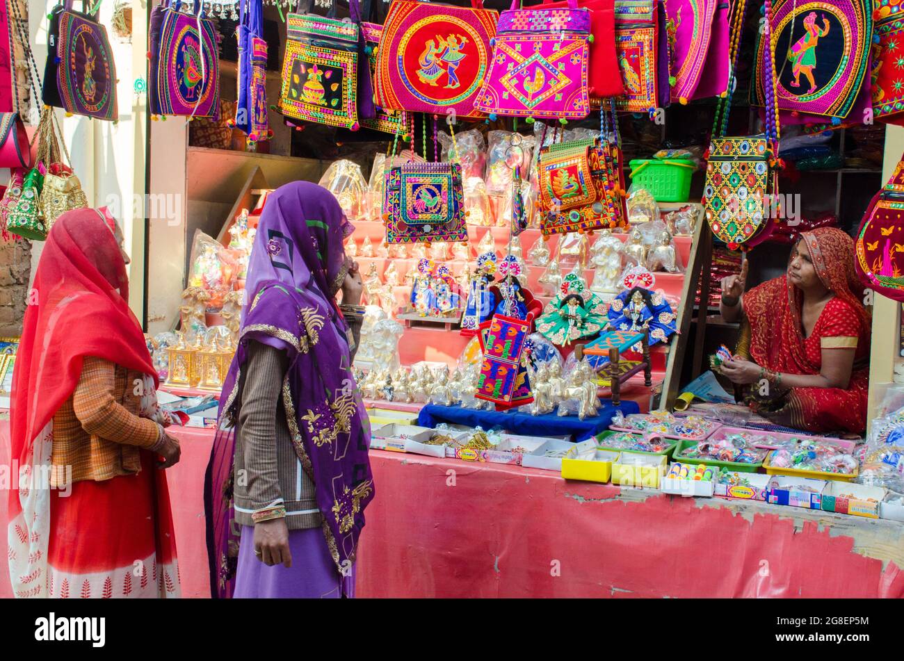 Devotees are visiting shops on the street of Mathura, Uttar Pradesh ...