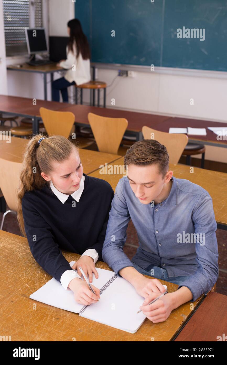 Girl explaining lesson to boy Stock Photo - Alamy
