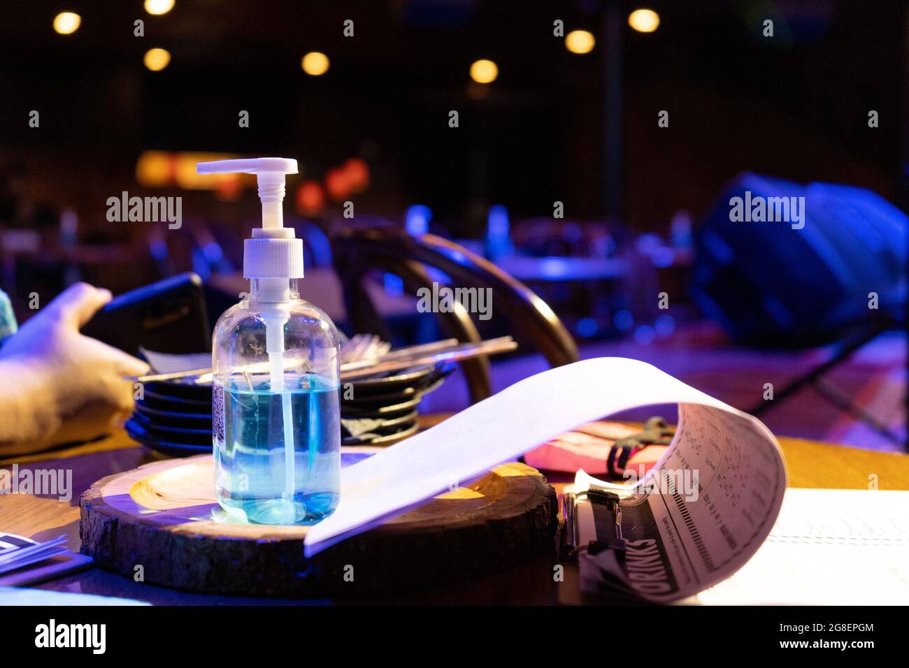 sanitizer placed on a restaurant table showing the new normal of hygine ...