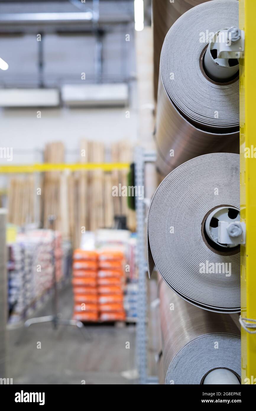 Rolled linoleum on display inside huge contemporary warehouse Stock ...