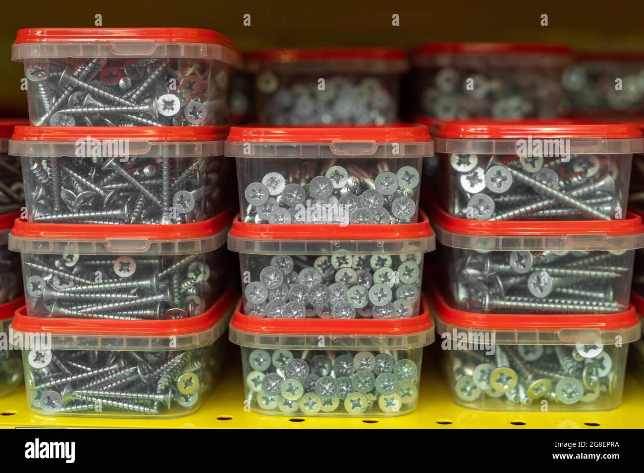 Stacks of plastic containers with nail assortment Stock Photo - Alamy