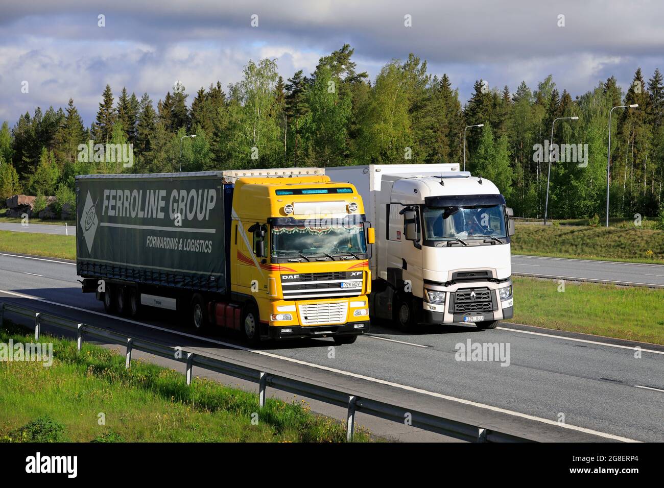 White Renault Trucks T semi trailer overtakes DAF XF lorry on motorway ...
