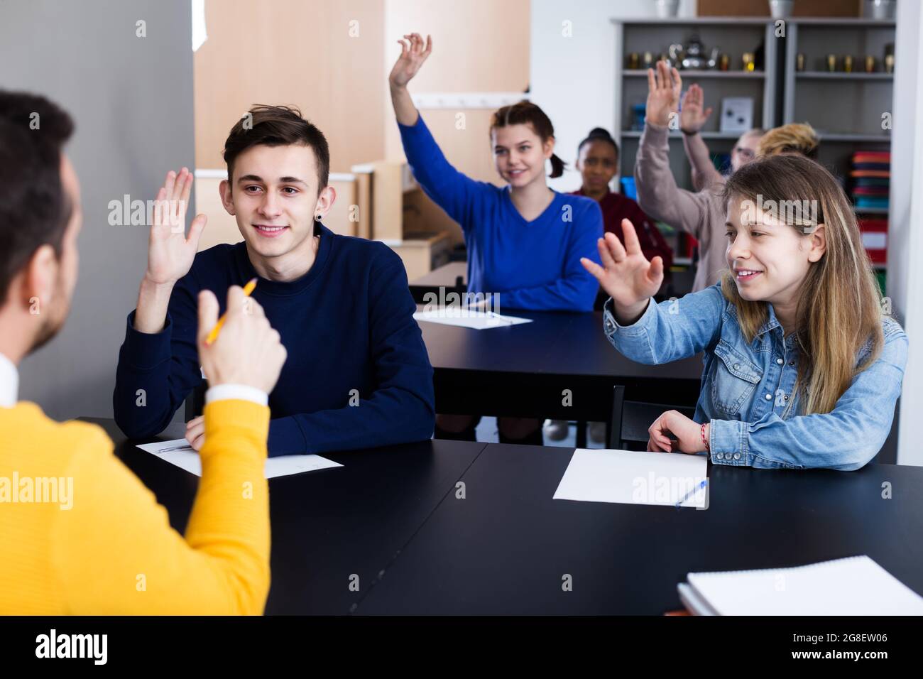 Class raising hands, ethnic hi-res stock photography and images - Alamy