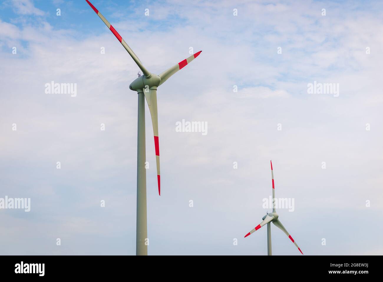 Two Wind turbines with blue sky background summer day.An ...