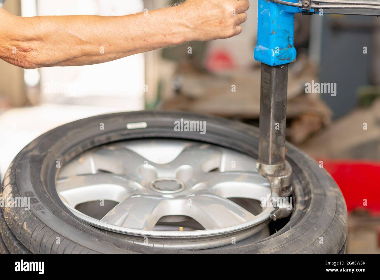 Mechanic changing tire in car service. Tire rotation machine.Car ...