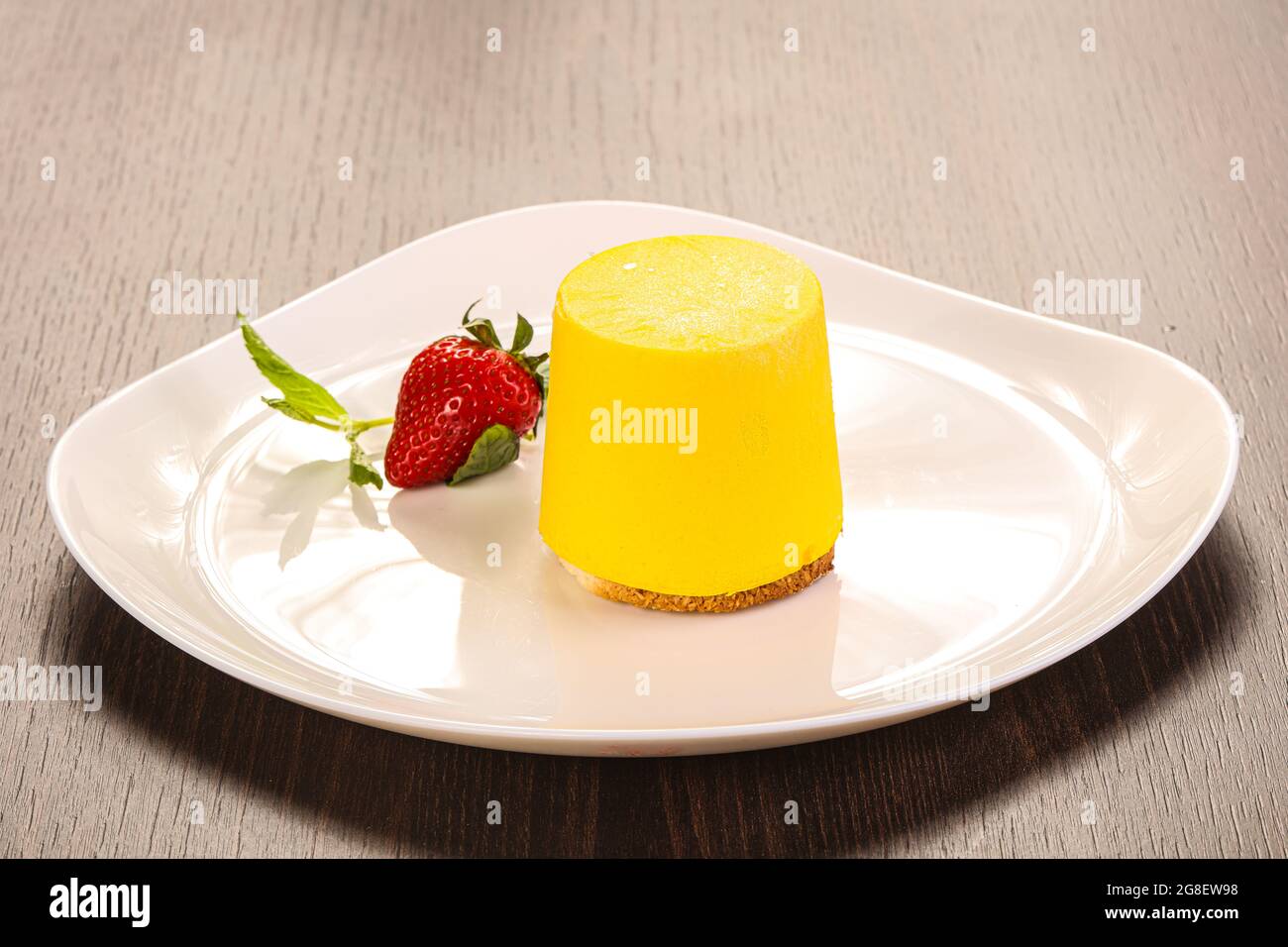 Sweet tasty mango bomb cake served strawberry Stock Photo - Alamy