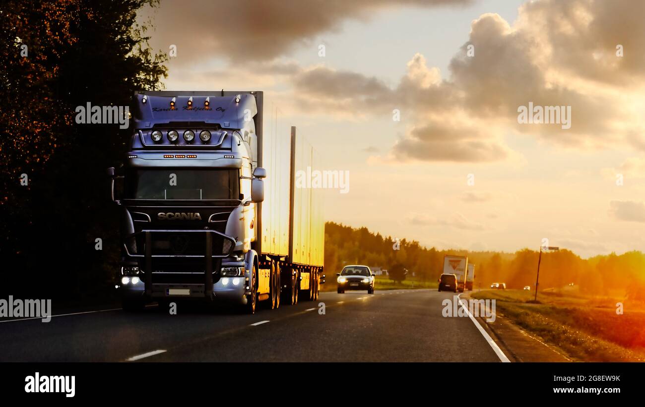 Customised ice blue Scania truck pulls trailer in highway traffic at ...