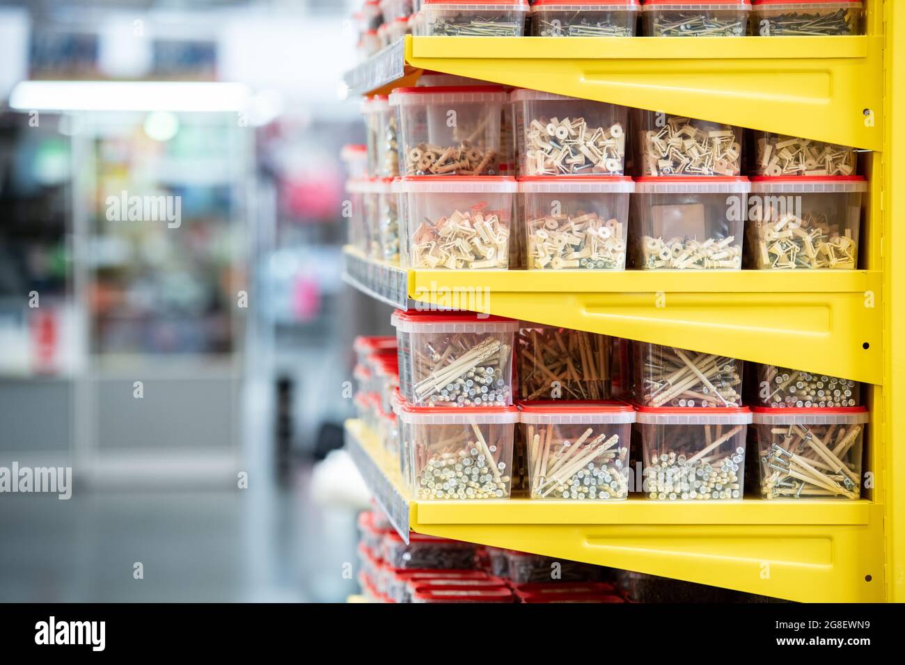Side view of shelves with stacks of plastic containers with nails Stock ...