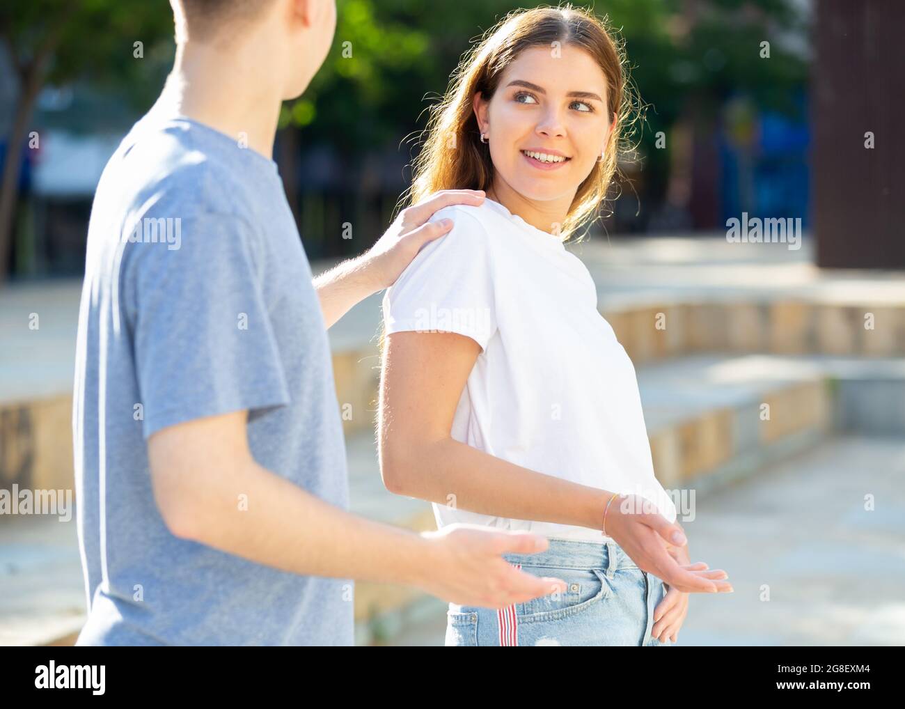 Young man is initiating a conversation with girl Stock Photo - Alamy