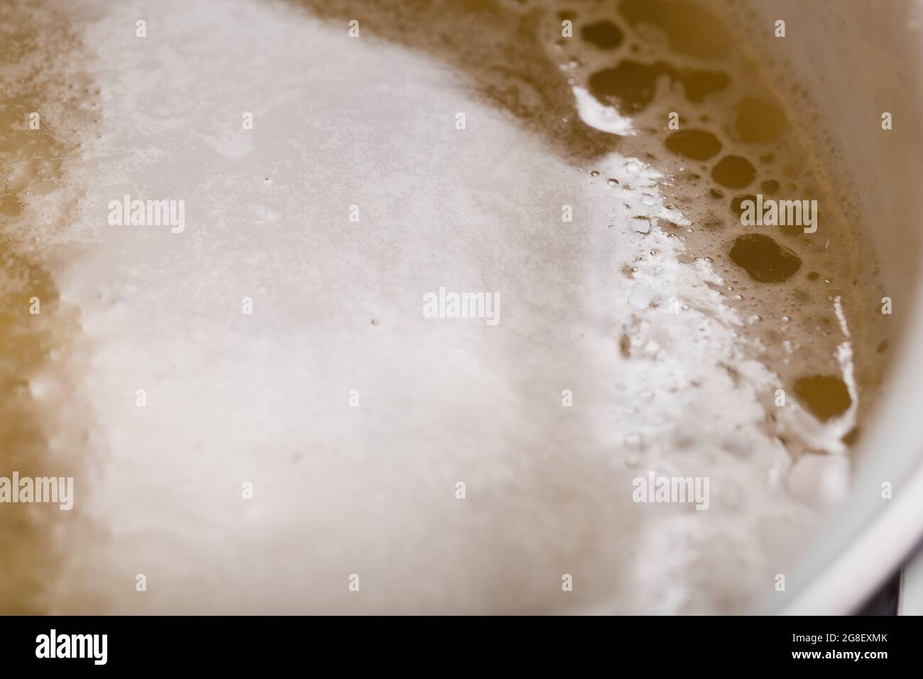Close-up of a drop of vegetable oil on the surface of a broth or vegan ...