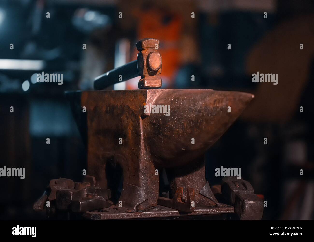 Large rusty anvil and hammer in the forge. Without people Stock Photo ...