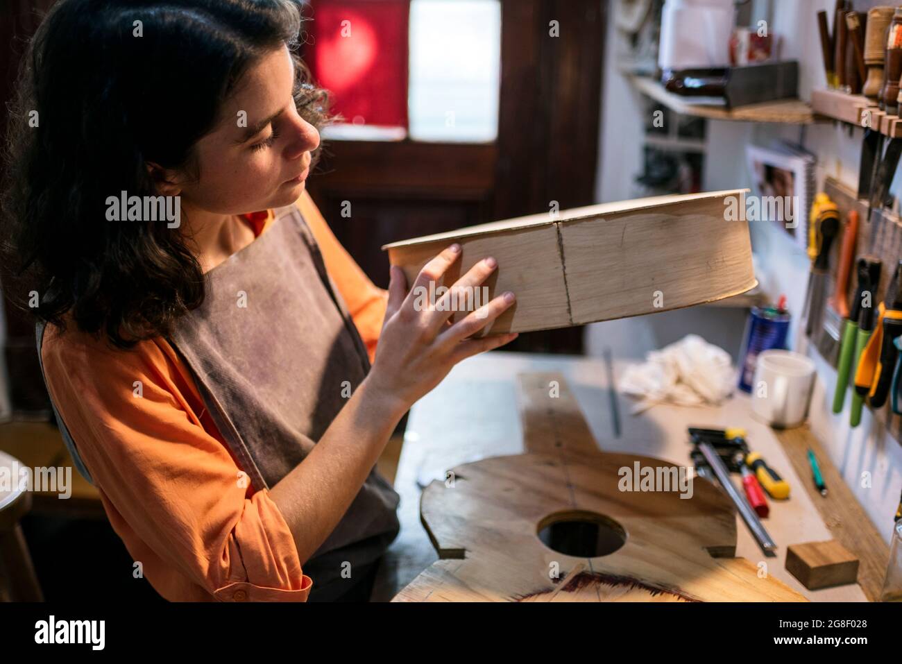 woman luthier making guitars in her musical instrument workshop Stock ...