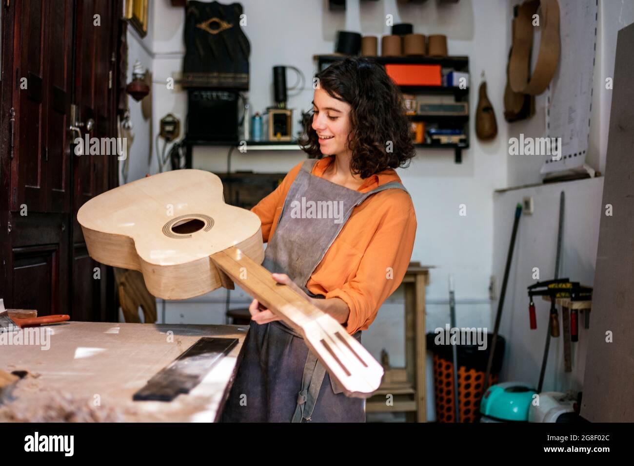 woman luthier making guitars in her musical instrument workshop Stock ...