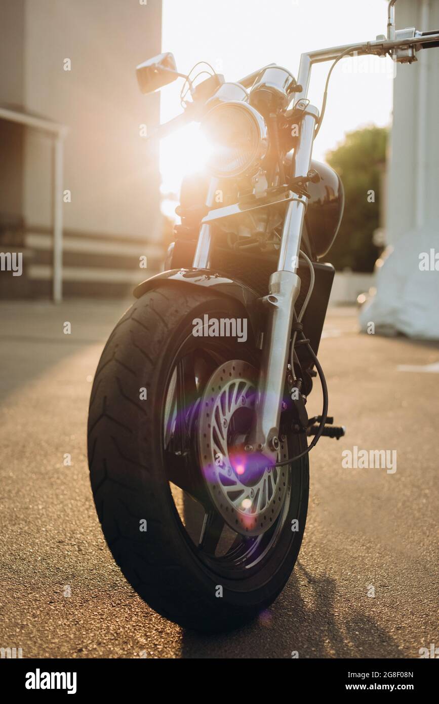 Freedom. Motorcycle in the parking lot in the rays of the sunset light ...