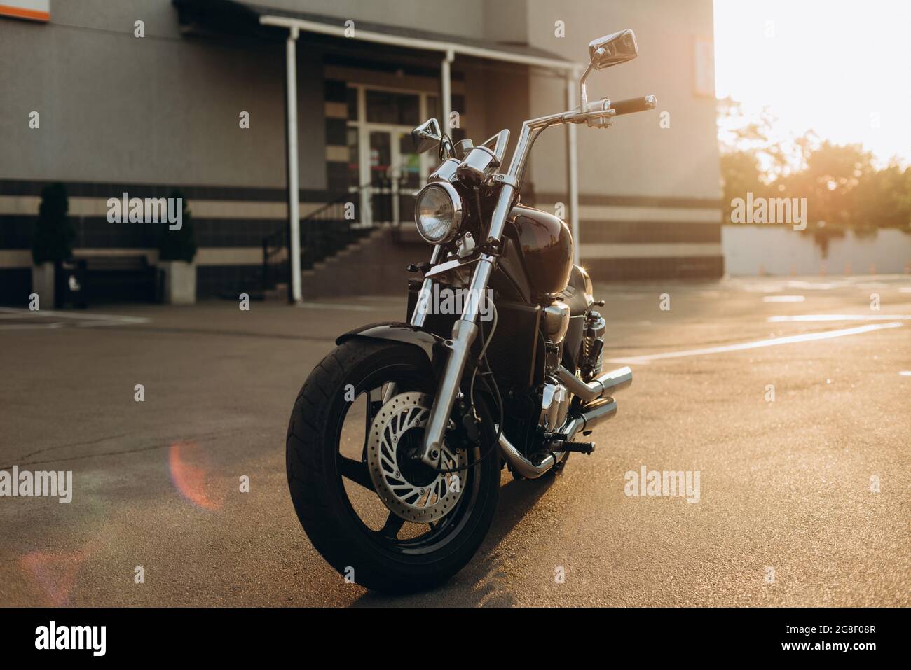 Freedom. Motorcycle in the parking lot in the rays of the sunset light ...