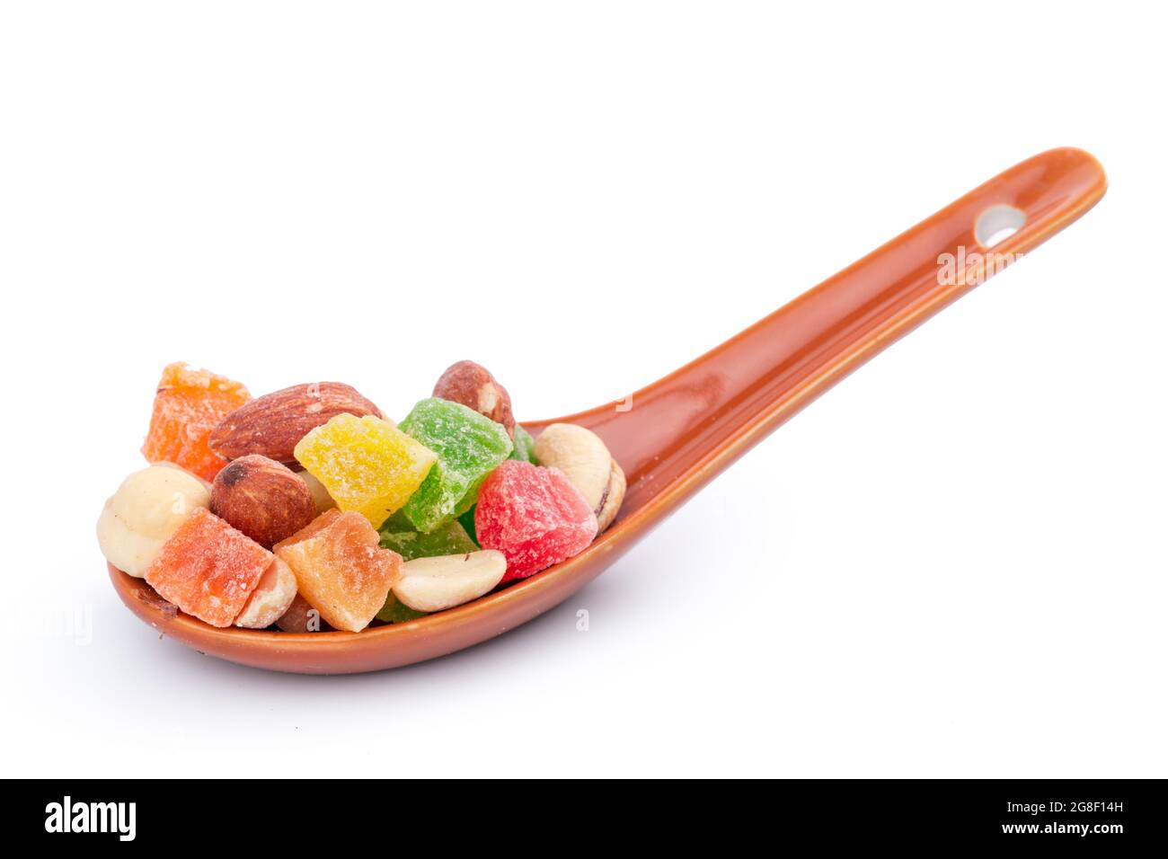 Heap of nuts and candied fruits in a spoon on white background Stock ...