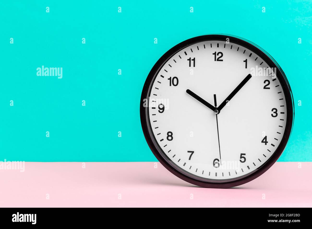 Wall Clock on color background Stock Photo - Alamy