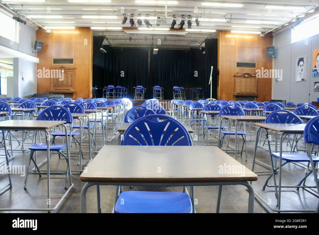 english school hall full of lines of chairs and tables for examinations ...