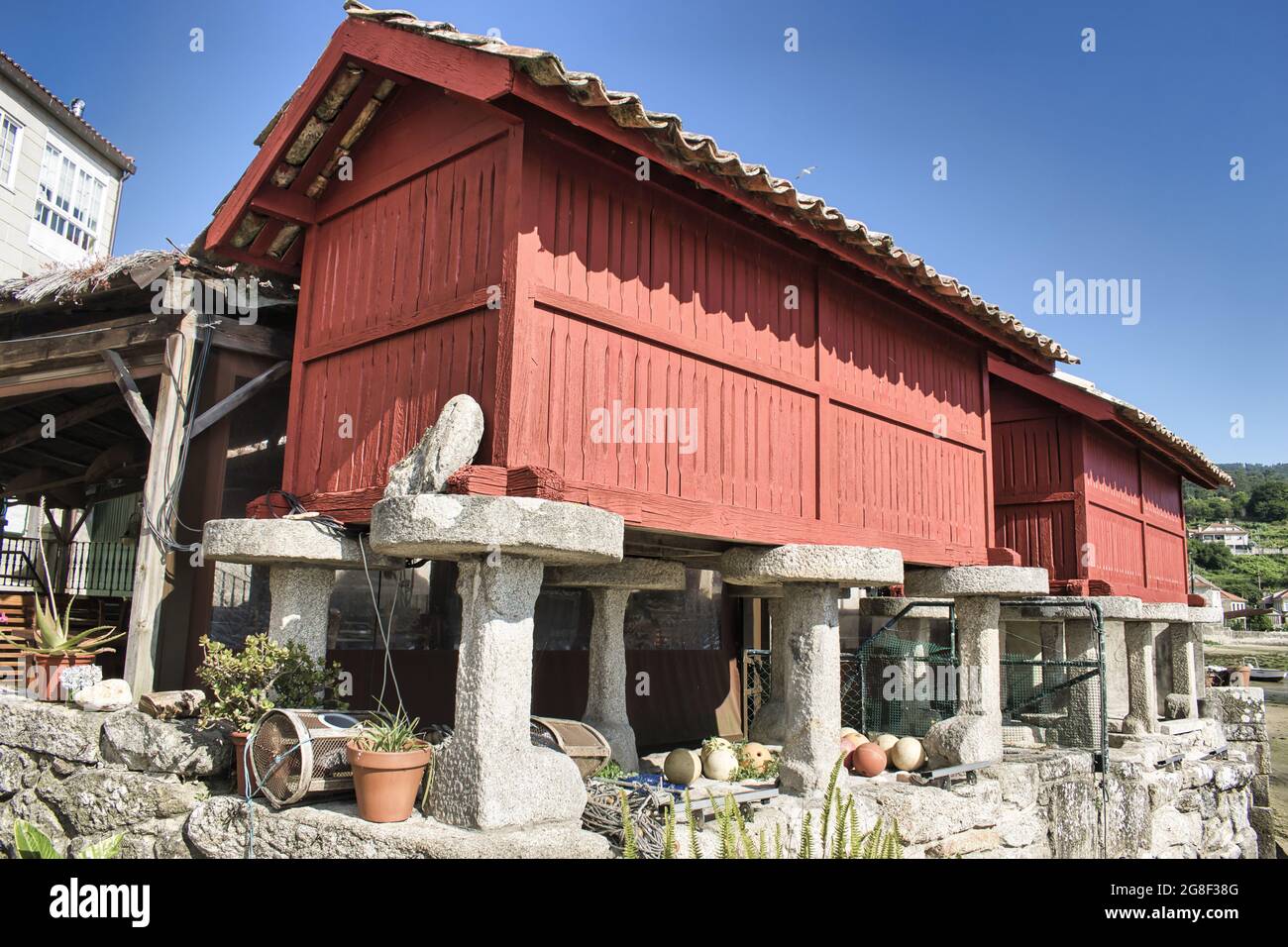 Traditional painted Galician barn in the village of Combarro, Spain ...
