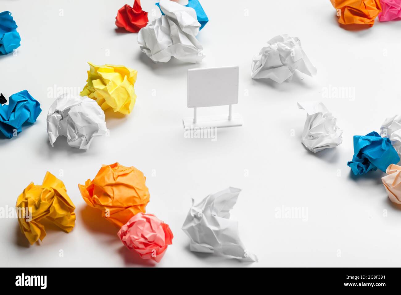 sheet of paper and crumpled wads on table Stock Photo - Alamy