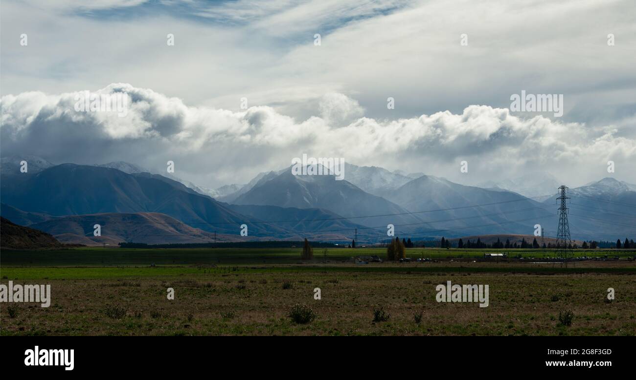 Panoramic view of Ben Ohau range with high voltage transmission towers and power lines in the ...
