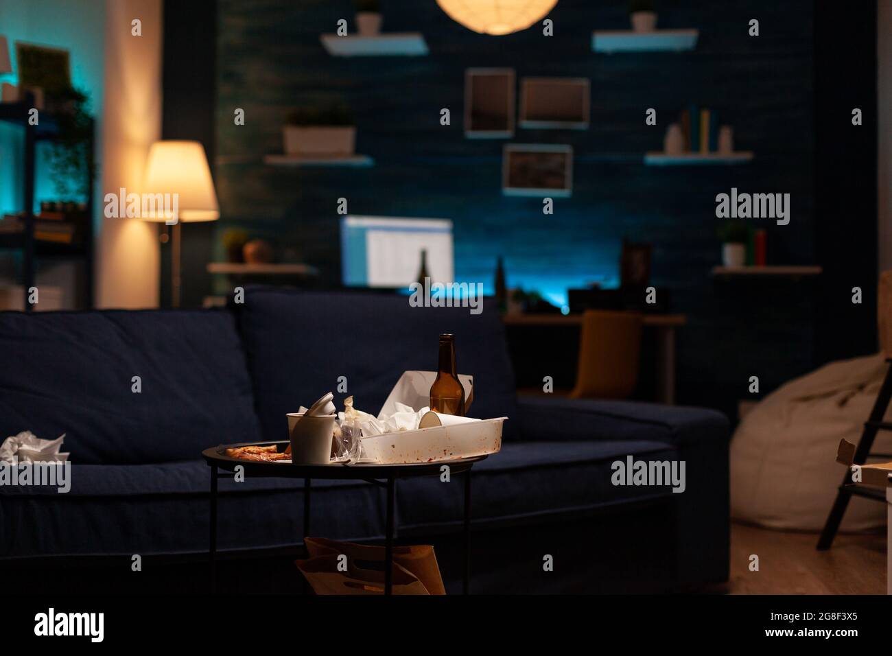 Chaotic empty living room of depressed person with scattered food mess ...