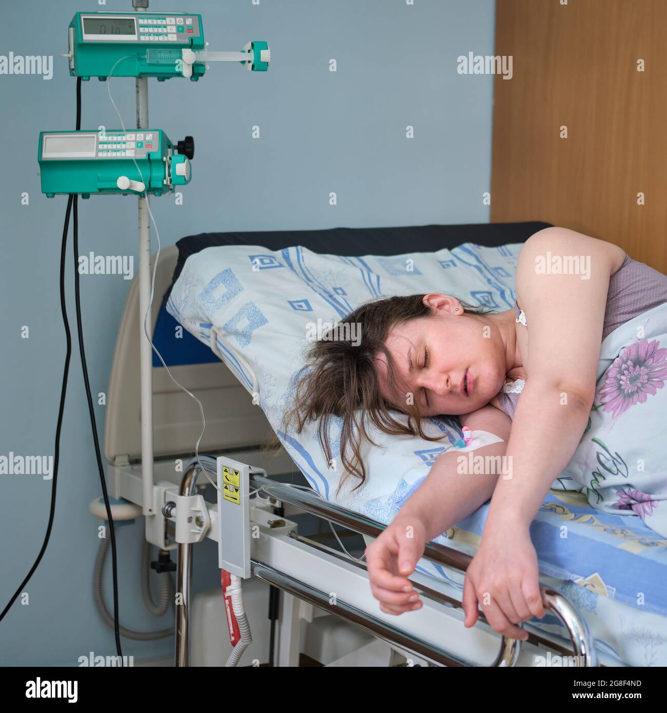 Woman on clinic bed with anesthesia at the time of labor pains. A ...