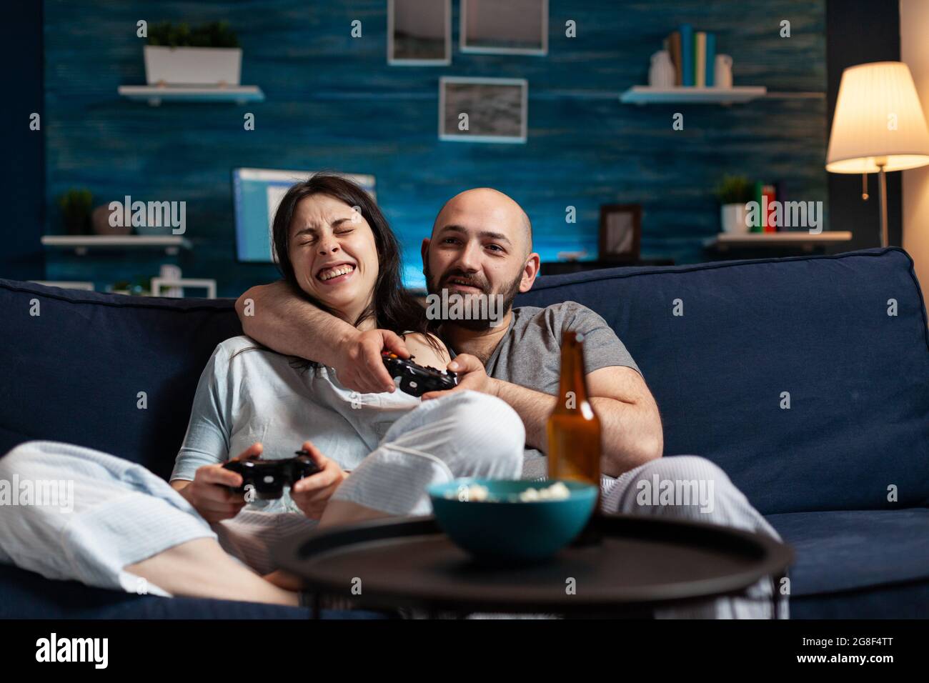 Determinated enthusiastic couple winning video games, hugged each other ...