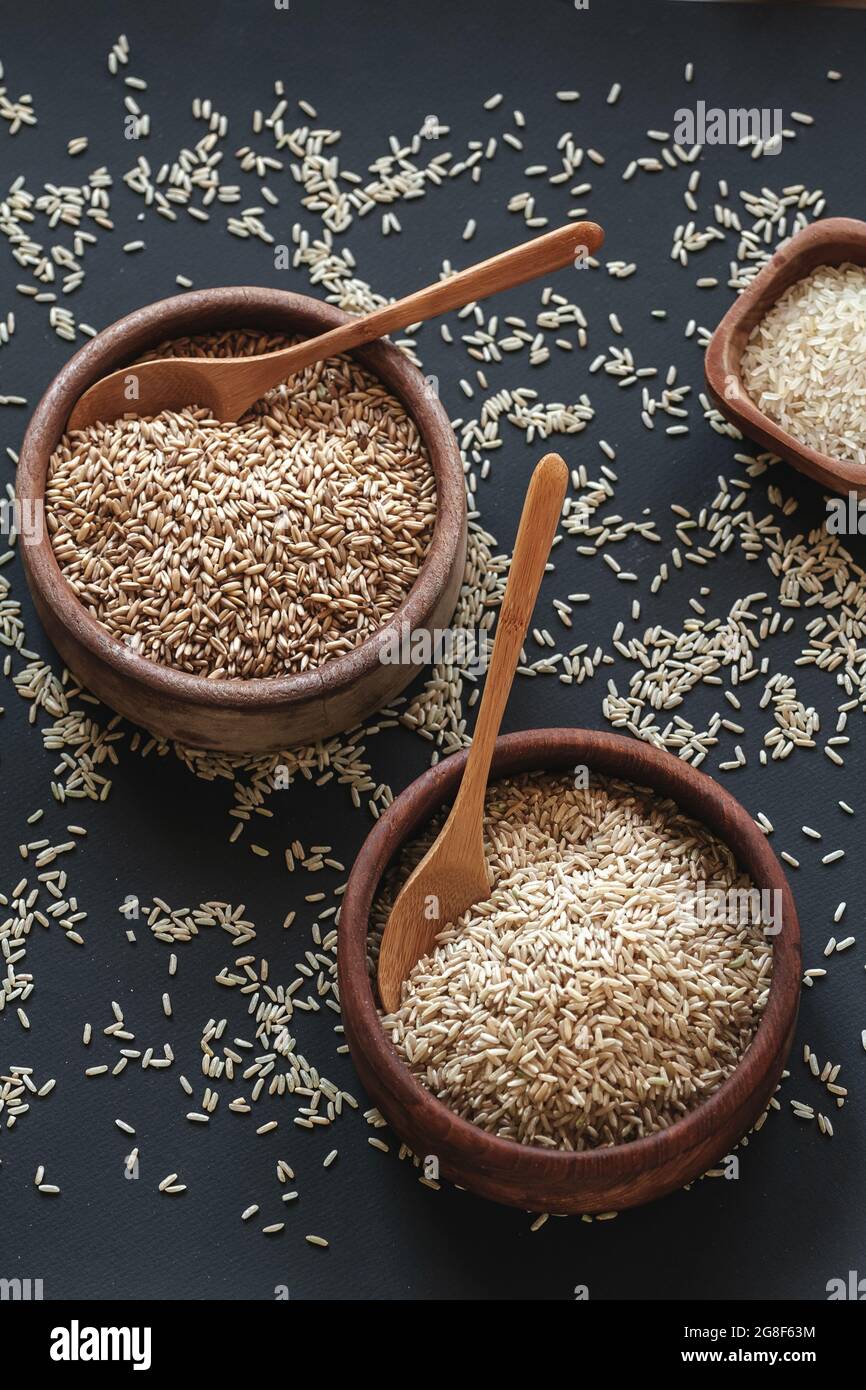 Set of different types of rice and cereals in wooden bowls and Stock ...
