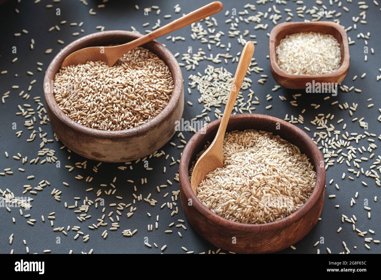 Set of different types of rice and cereals in wooden bowls and Stock ...