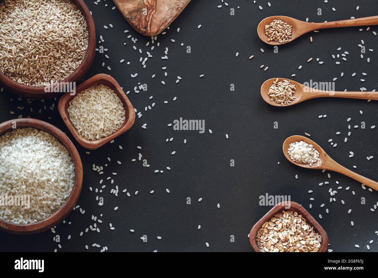 Cooking background of different types of rice and cereals in woo Stock ...