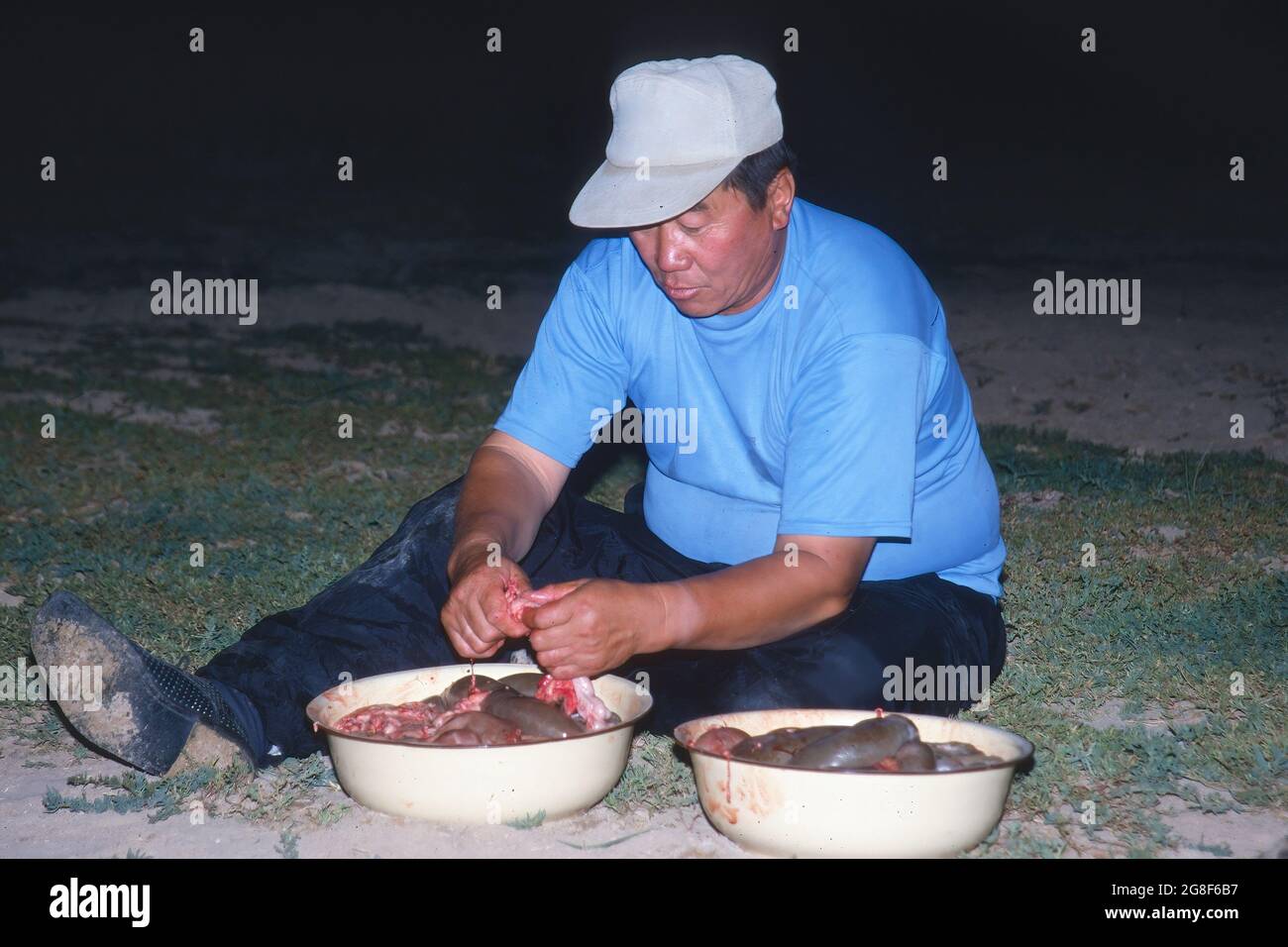 Butcher cleaning intestines during a traditional sheep killing in the ...