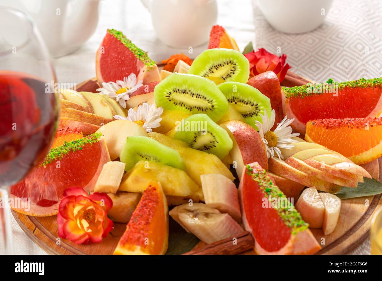 Assorted sliced tropical fruits on plate hi-res stock photography and ...
