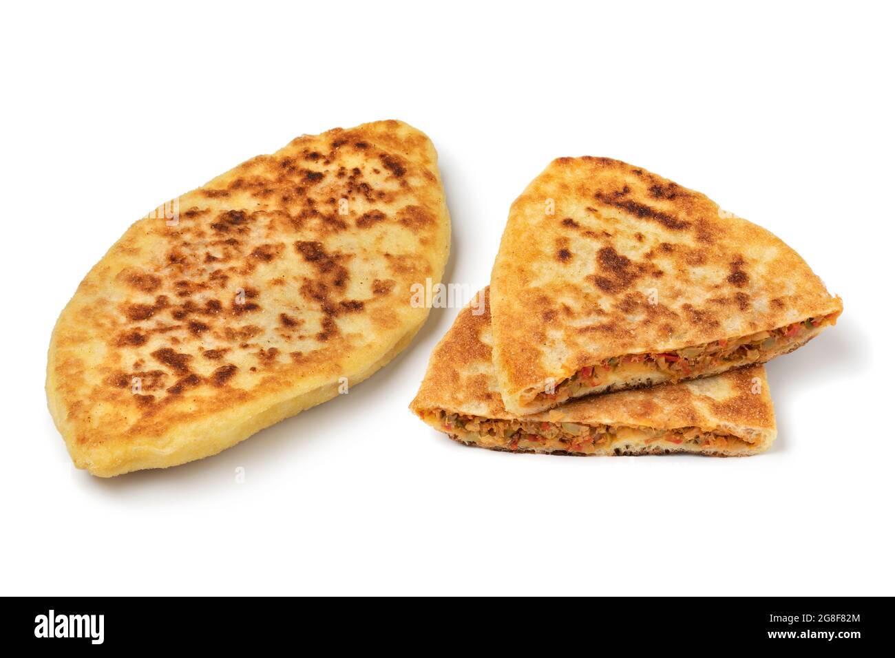 Fresh baked whole and half Moroccan stuffed batbot isolated on white ...