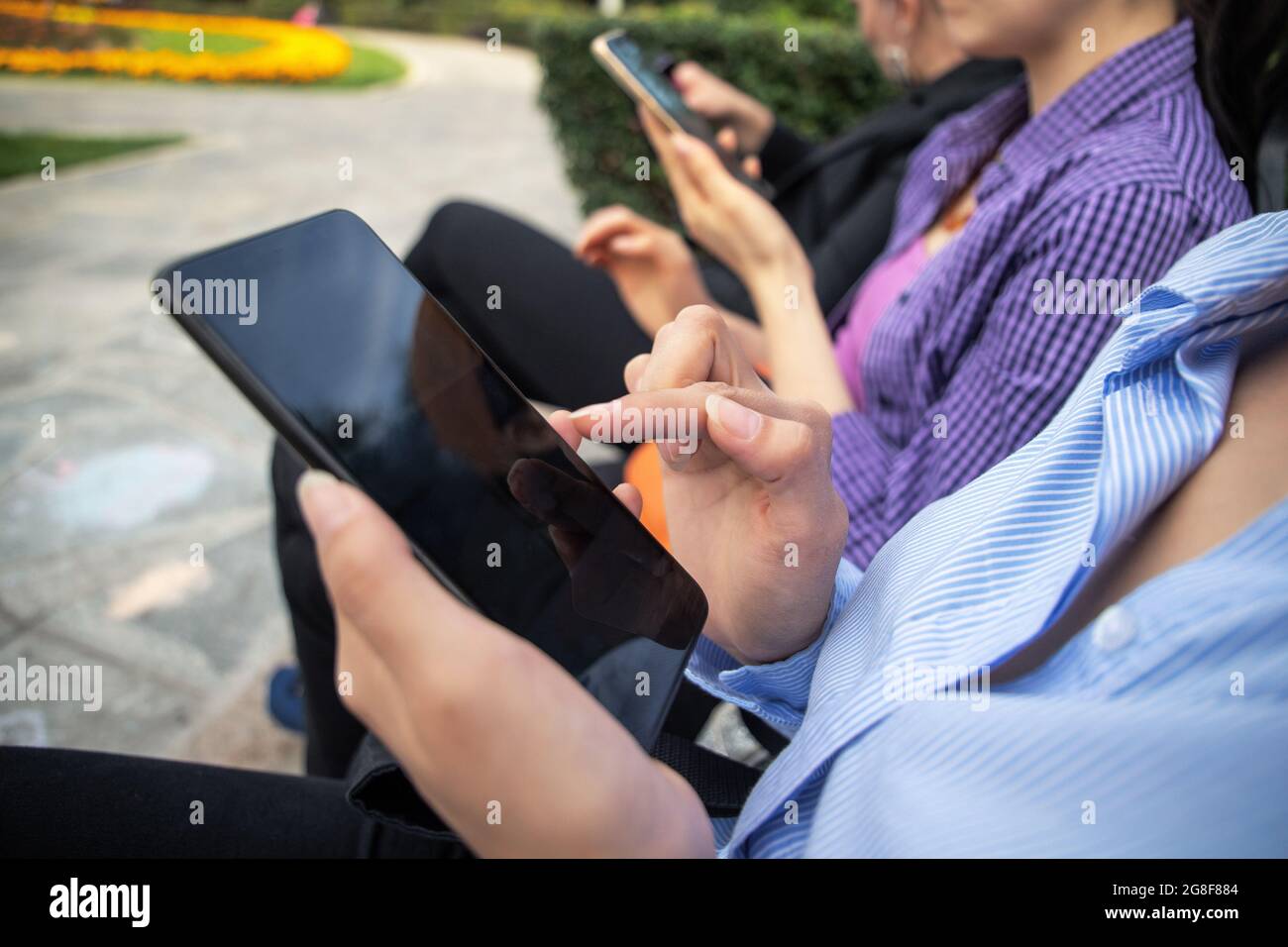 Womans hands holding smartphone outdoors hi-res stock photography and ...
