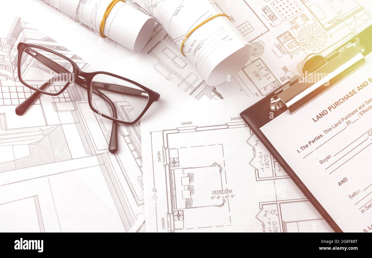 Building house on blueprints, construction project. Working on building ...