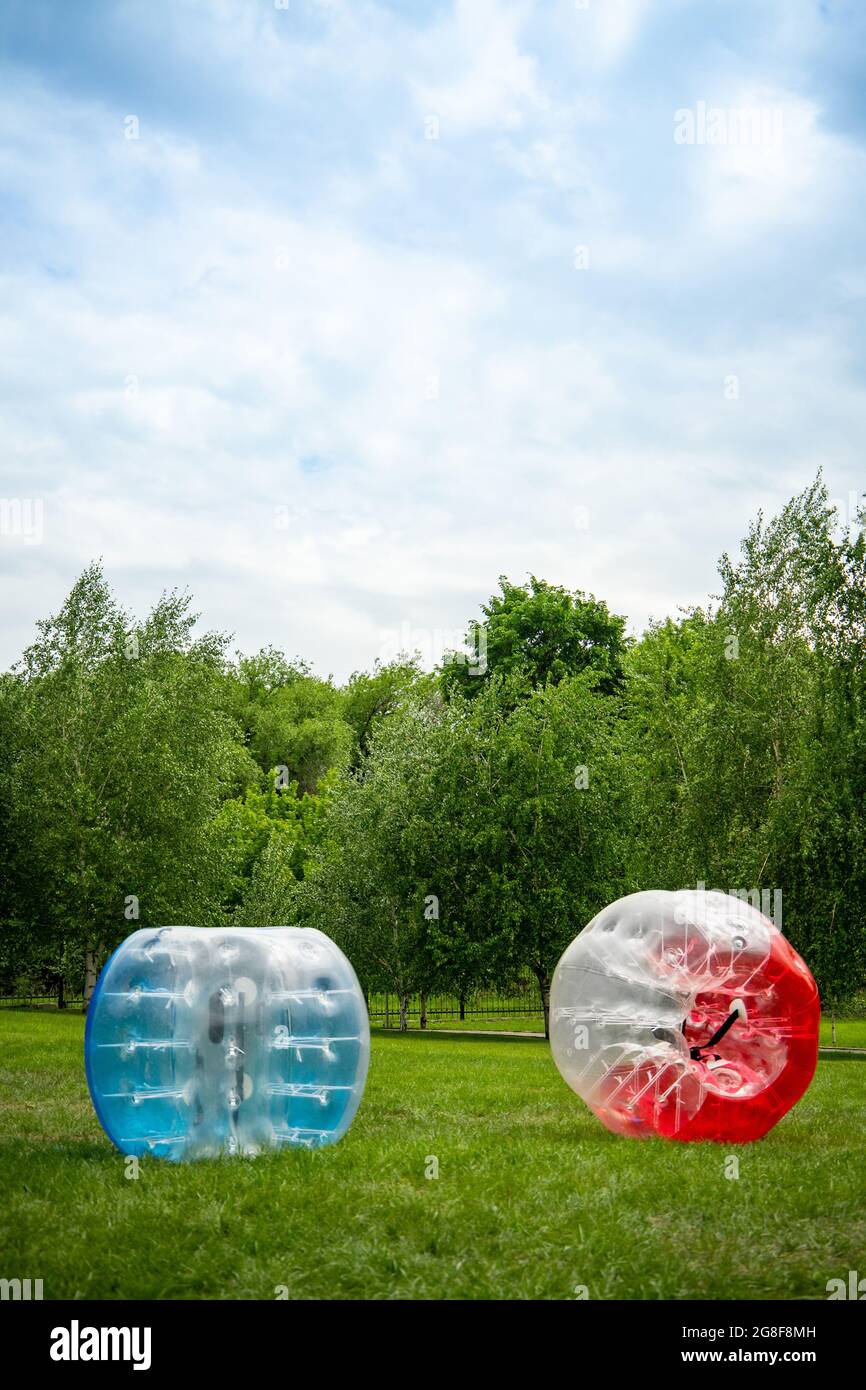 2 Zorbing Balloon on the summer lawn. inflatable zorb ball outdoor ...