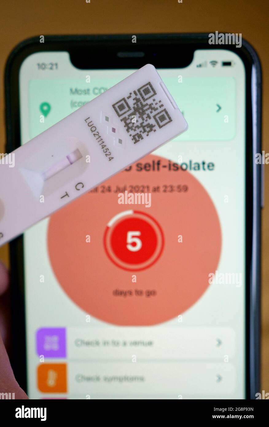 A negative lateral flow test next to advice from the NHS COVID app on ...