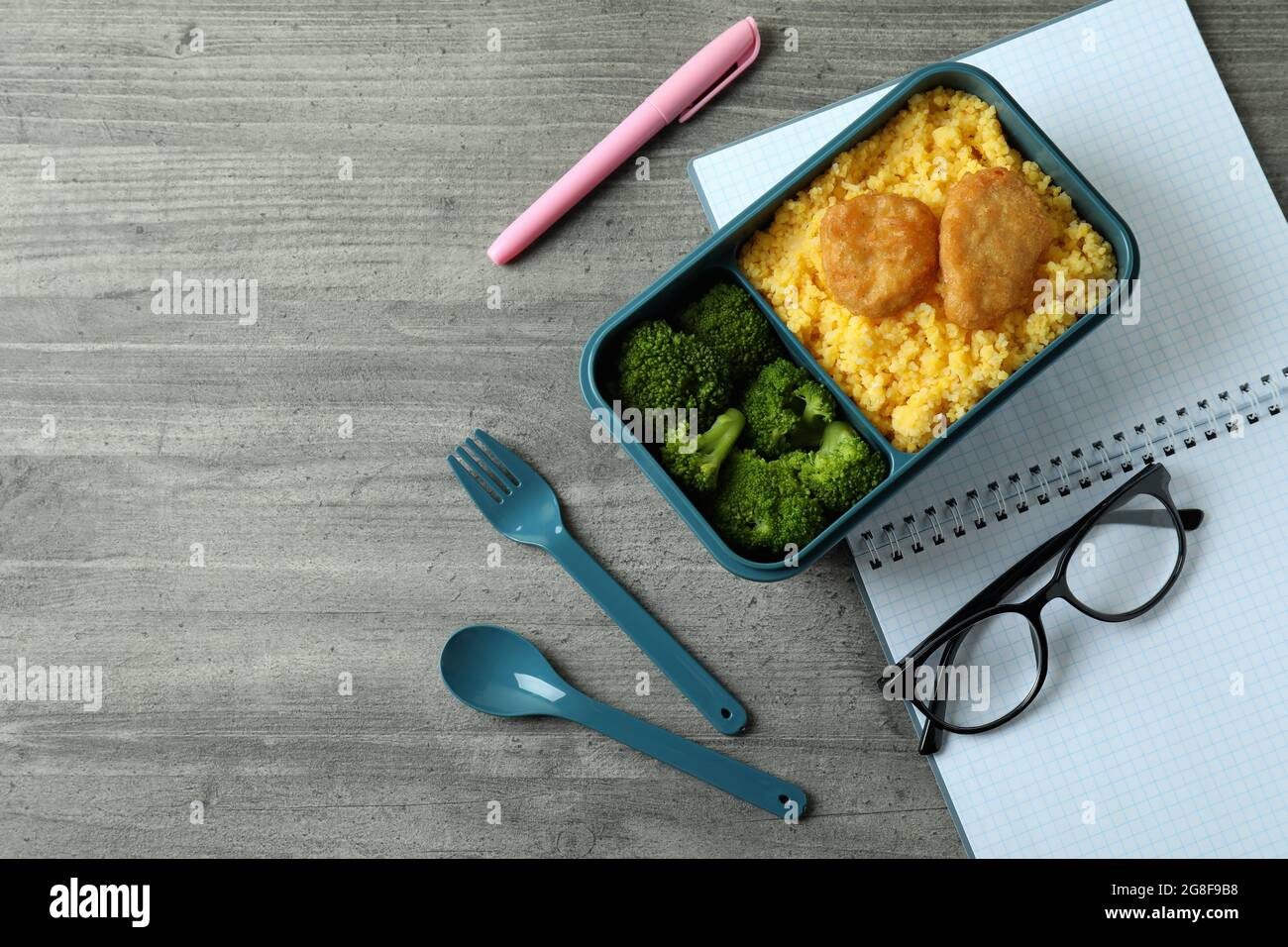 Workplace with lunch box on gray textured table Stock Photo - Alamy