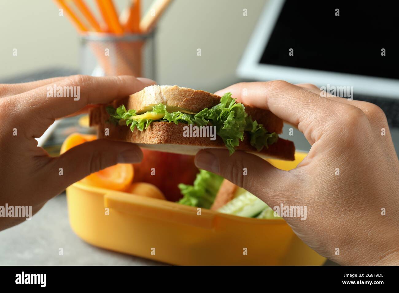 Workplace eating with female hands hold sandwich, close up Stock Photo ...