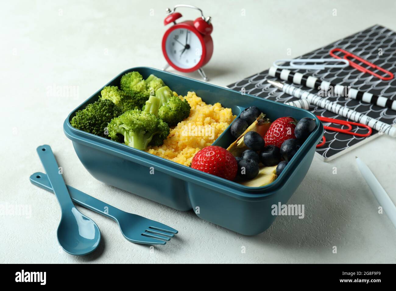 Study concept with lunch box on white textured table Stock Photo - Alamy