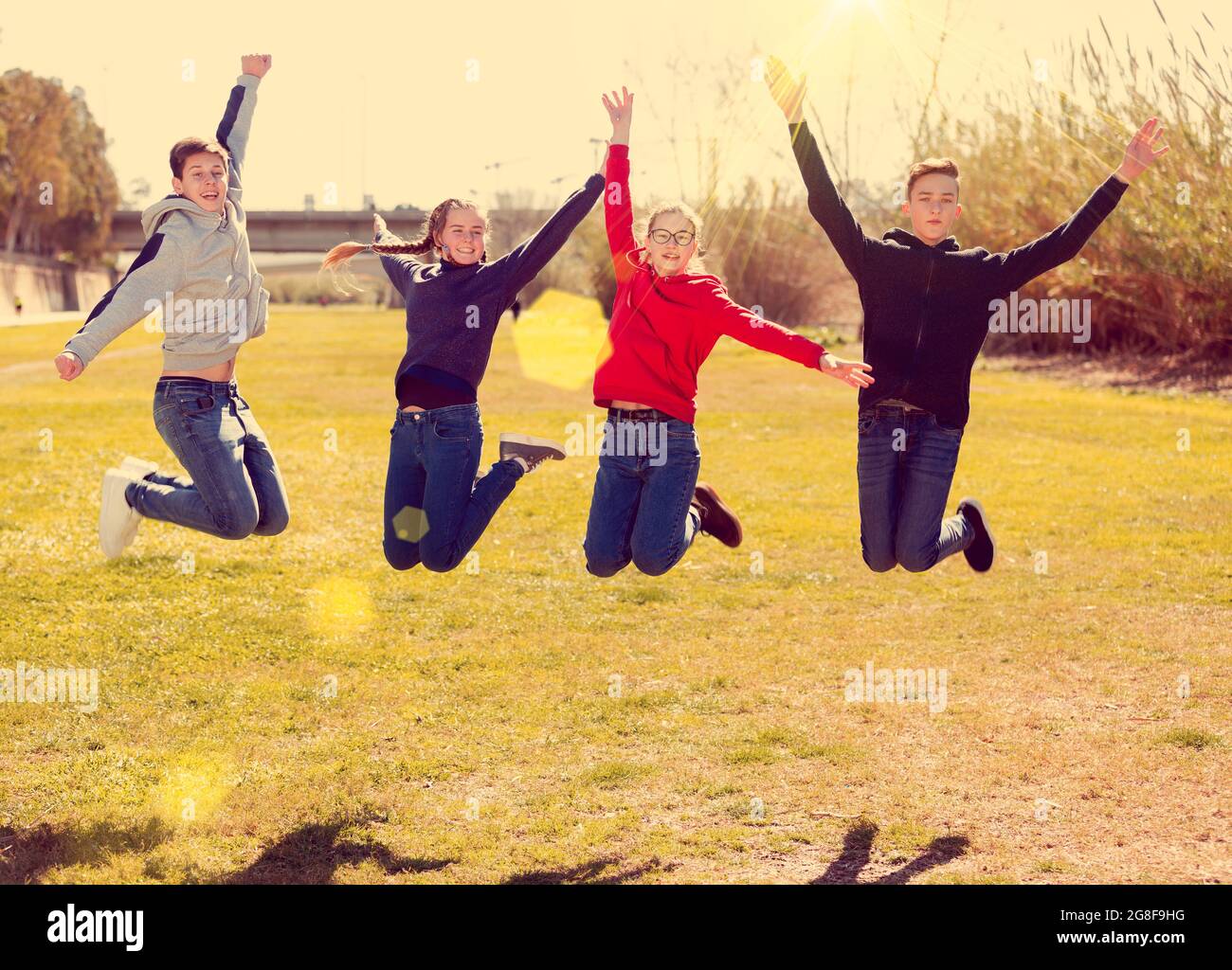 Portrait four happy friends jumping hi-res stock photography and images ...